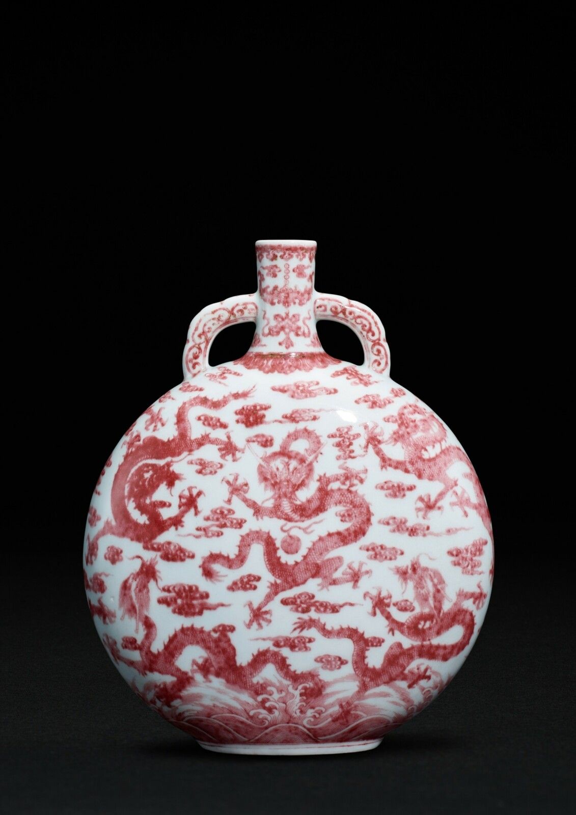 An exceptionally rare and finely painted copper-red 'nine dragon' moon ...