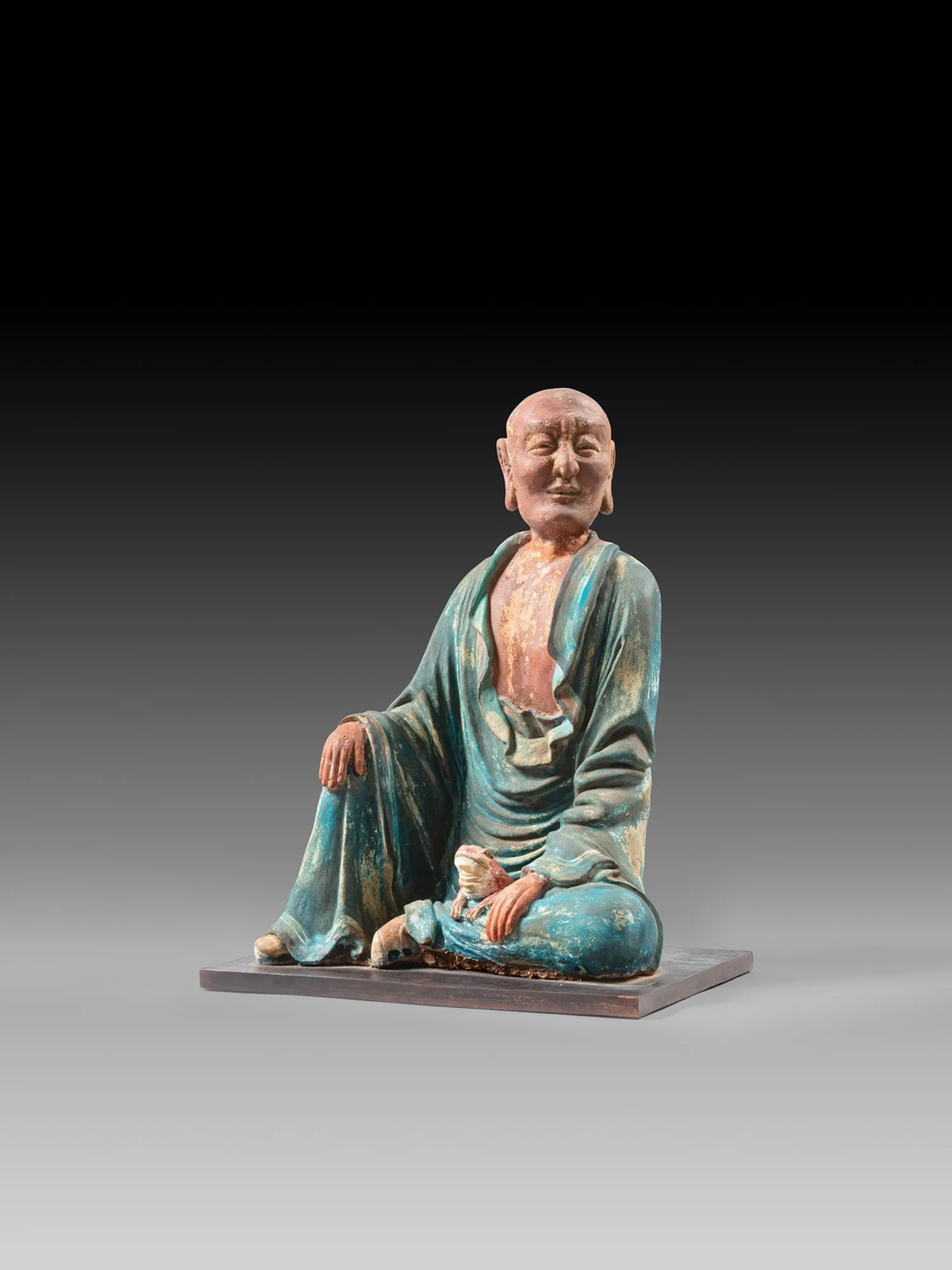 A polychrome stucco figure of a seated luohan, Late Ming dynasty-Early ...