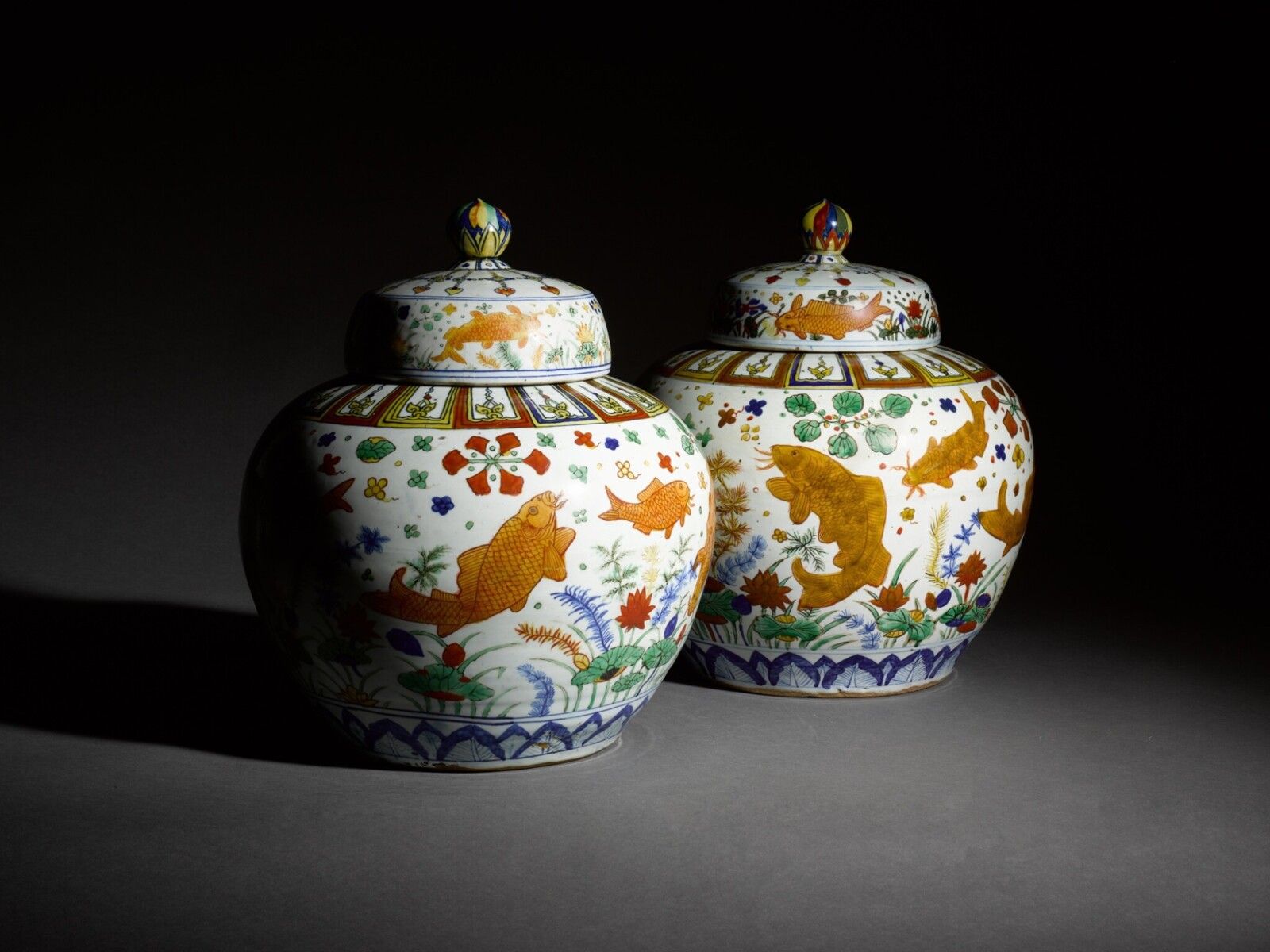 An exceptionally rare and magnificent pair of wucai 'fish' jars and ...